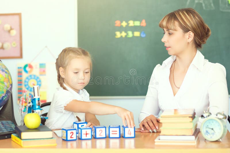 Cute Schoolgirl and Her Teacher in a Classroom Stock Photo - Image of ...