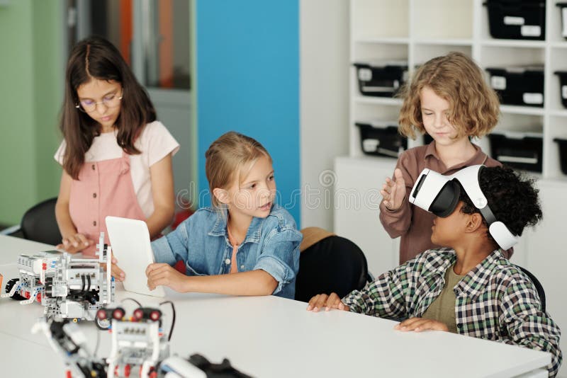 Cute Schoolgirl with Tablet Looking at Her Classmate in Vr Headset ...