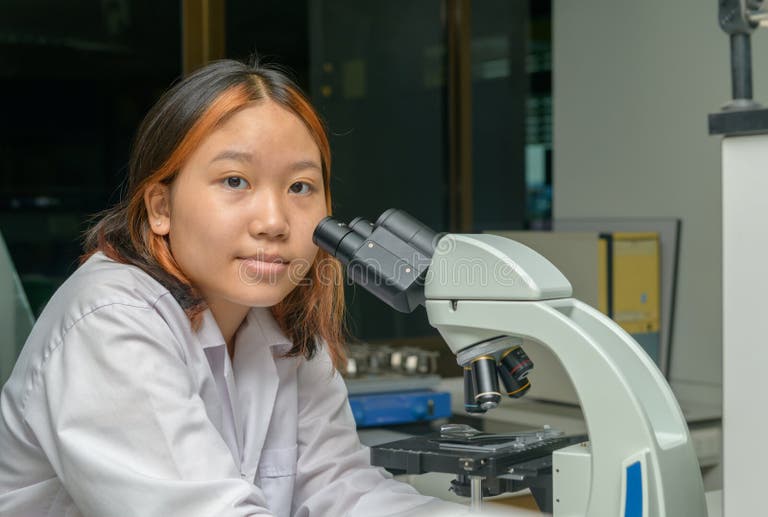 Cute Scientist Schoolgirl in Lab Coat Looks through Microscope for ...
