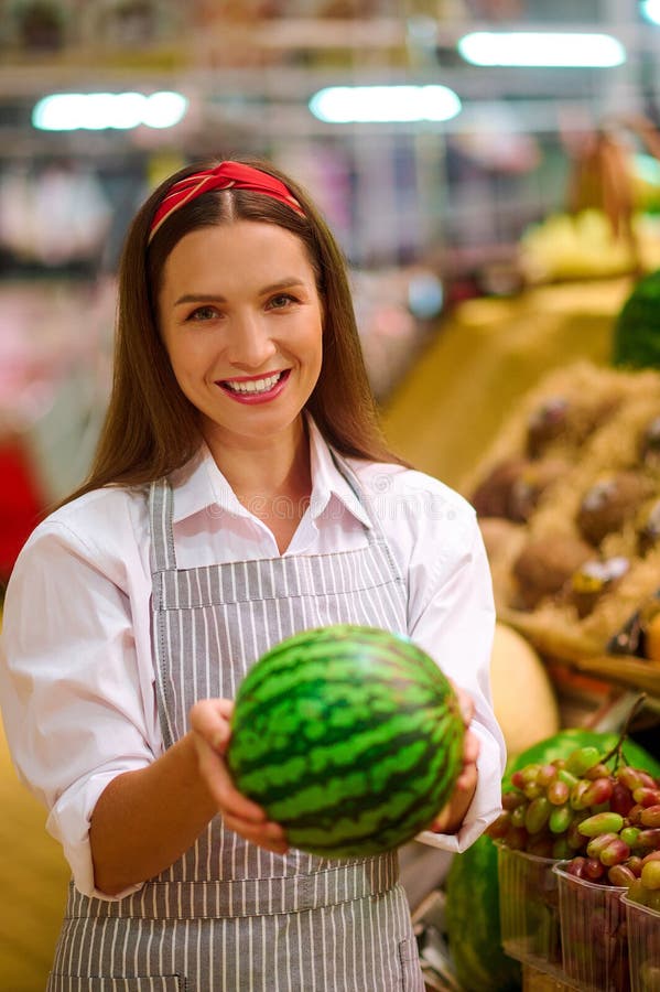 A Cute Seller Selling Watermelons in a Vegetable Store Stock Photo ...