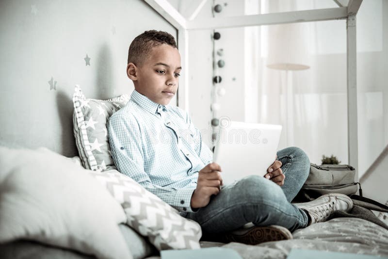 Cute Serious Boy Looking at the Tablet Screen Stock Photo - Image of ...