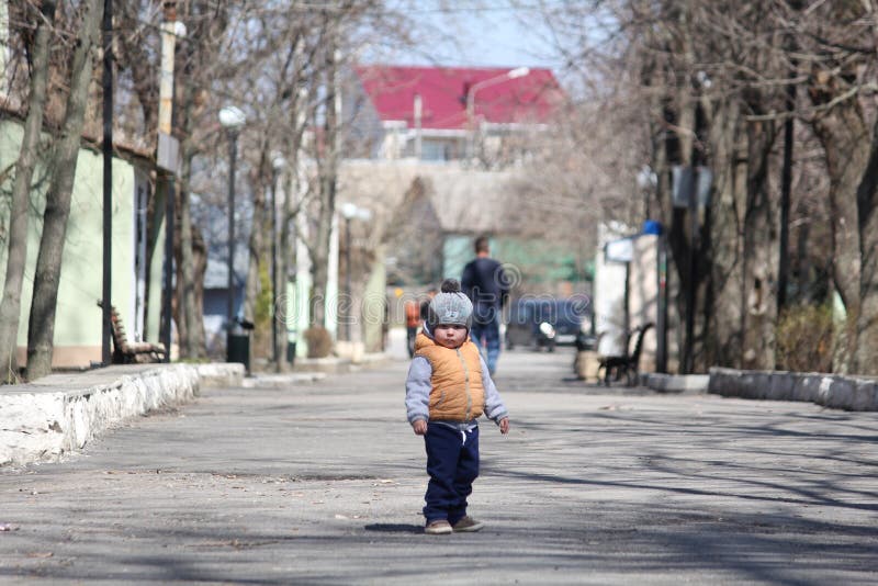 Cute Child Standing on the Path in the Spring Park Stock Photo - Image ...