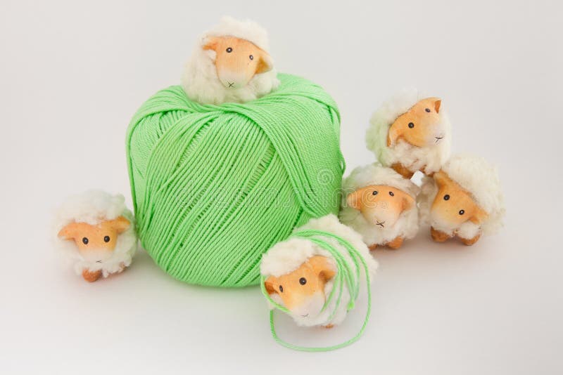 Cute Sheep Playing Together with a Ball of Green Wool Stock Image ...