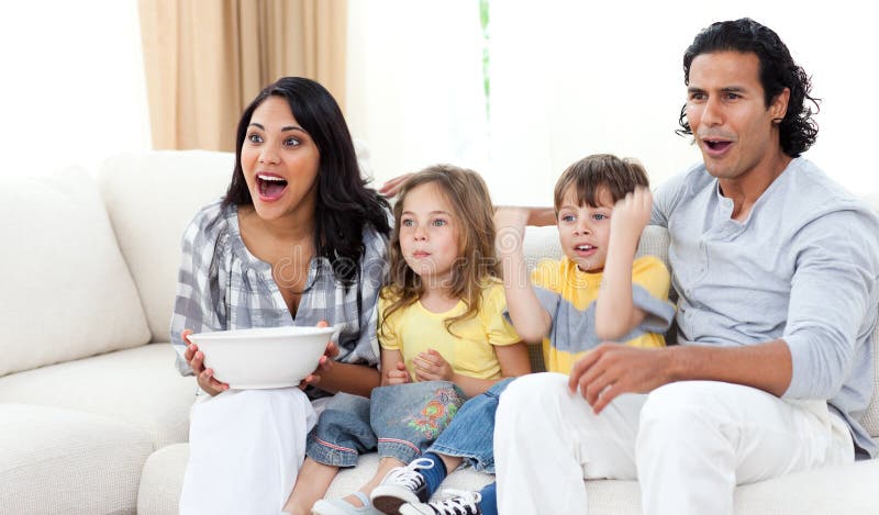 Family Sitting in Living Room with Remote Control Stock Photo - Image ...