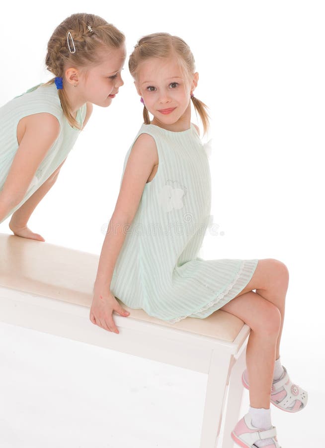 Cute Sisters Having Fun Sitting on a Chair. Stock Image - Image of ...