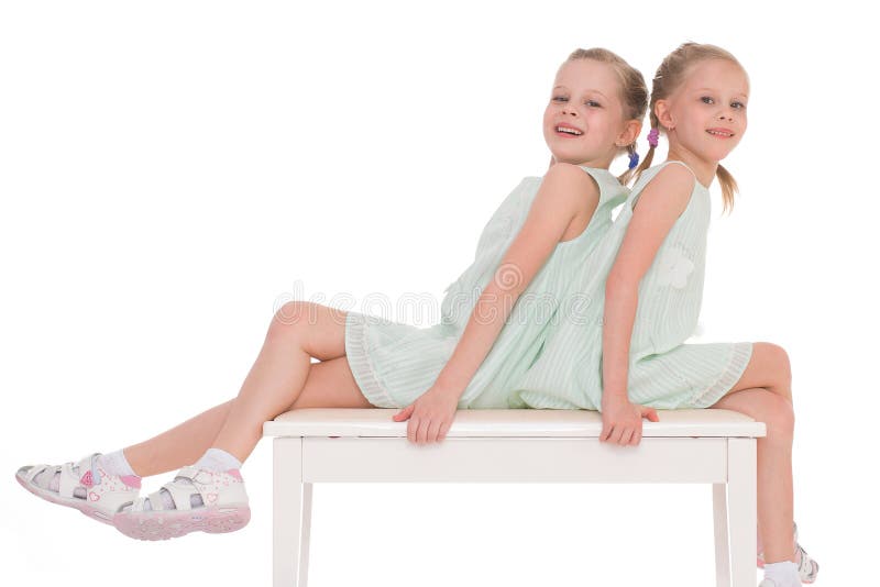 Cute Sisters Having Fun Sitting on a Chair. Stock Image - Image of ...