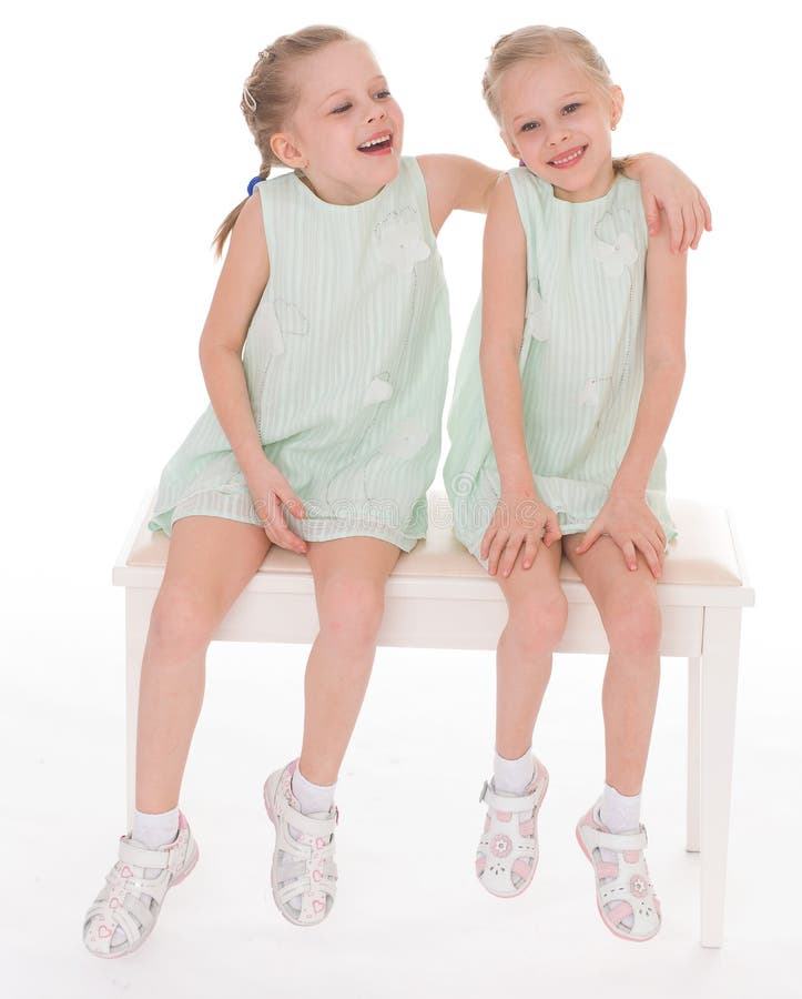Cute Sisters Having Fun Sitting on a Chair. Stock Image - Image of ...