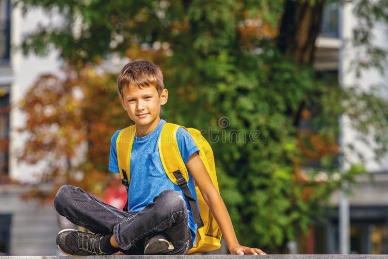Sad Boy with Backpack Sitting Alone in the Corner in the Staircase ...