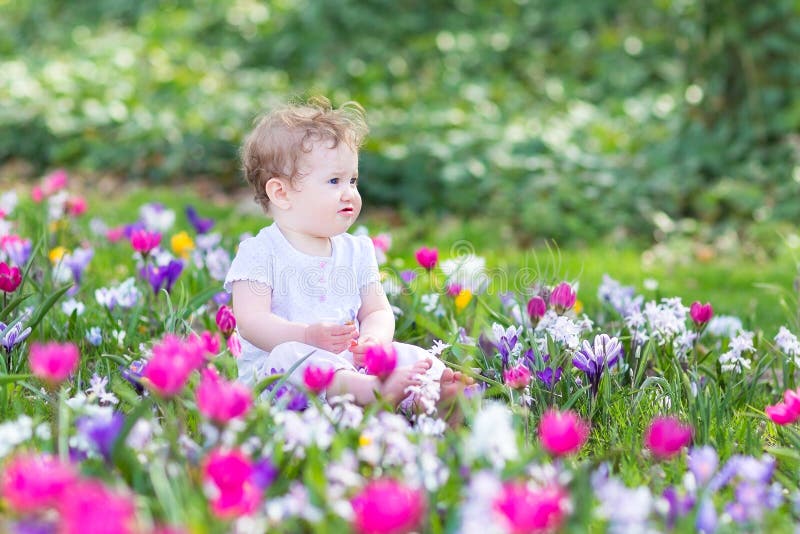 Cute Smiling Baby Playing with First Spring Flowers Stock Photo - Image ...