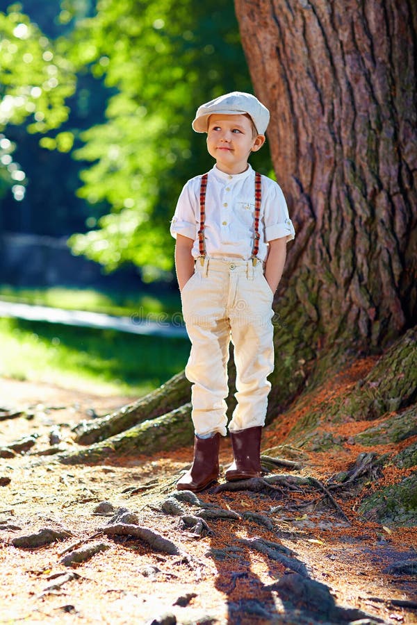 Cute Smiling Boy Near Old Tree Stock Photo - Image of farmer, clothes ...