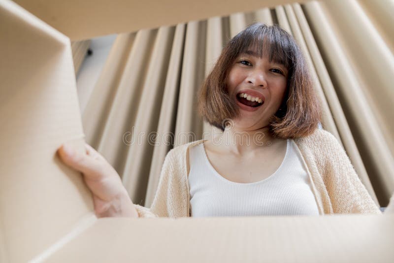A Cute Smiling Woman Opened the Box and Looked Inside Stock Image ...
