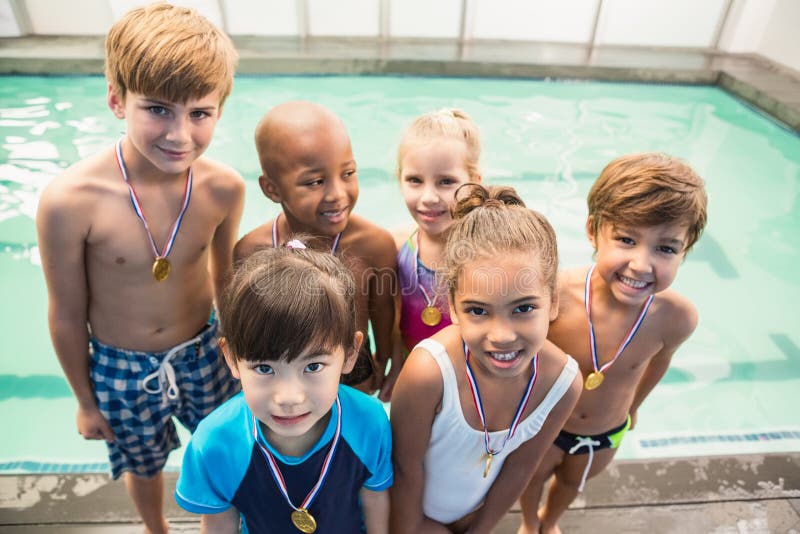 Cute Swimming Class Smiling Poolside with Medals Stock Photo - Image of ...