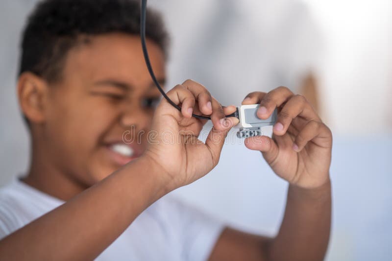 A Cute Teen Looking Busy while Assembling Some Small Pieces Stock Image ...