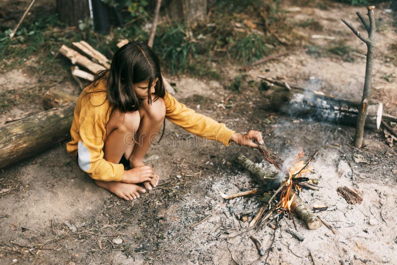 A Cute Teenage Girl Keeps the Fire Burning while Relaxing in the Forest ... A Cute Teenage Girl Keeps the Fire Burning while Relaxing in the Forest ...