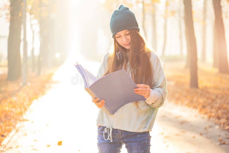 Cute Teenage Girl Reading in Park Stock Photo - Image of foggy ...