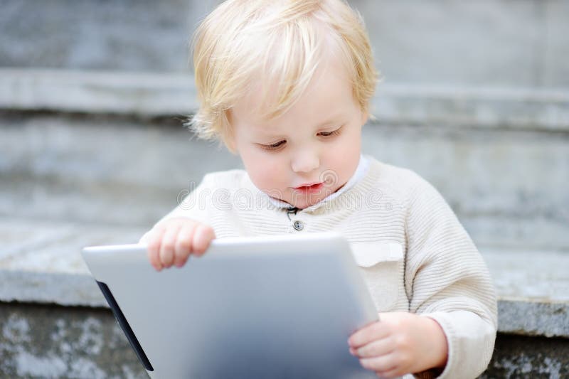 Cute Toddler Boy Playing with a Digital Tablet Stock Photo - Image of ...