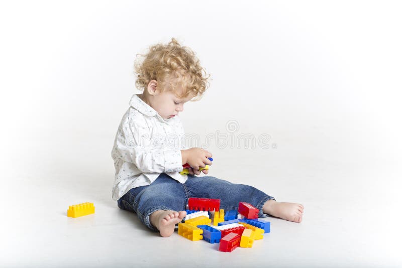 Cute Toddler Is Building With Legos Stock Image - Image of looking ...