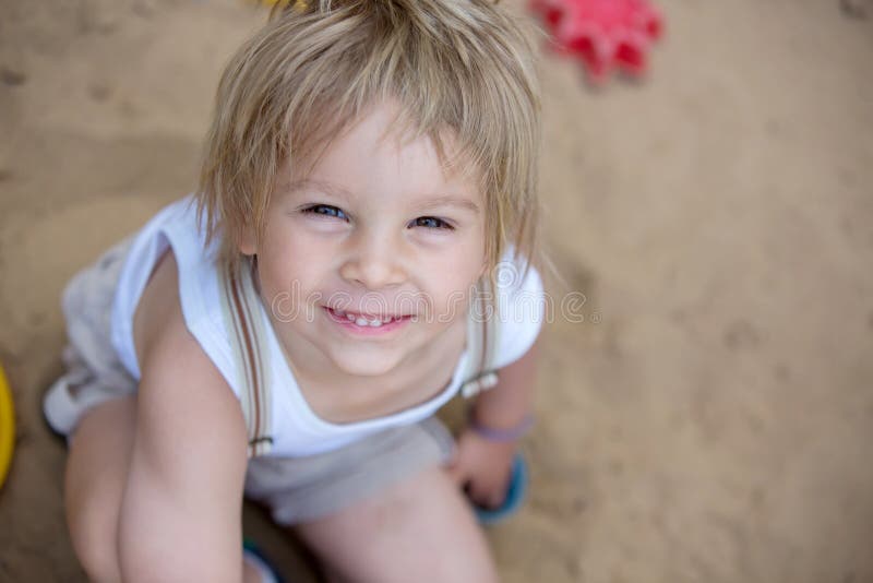 Cute Toddler Child, Blond Boy, Playing in the Sandpit in the Park Stock ...