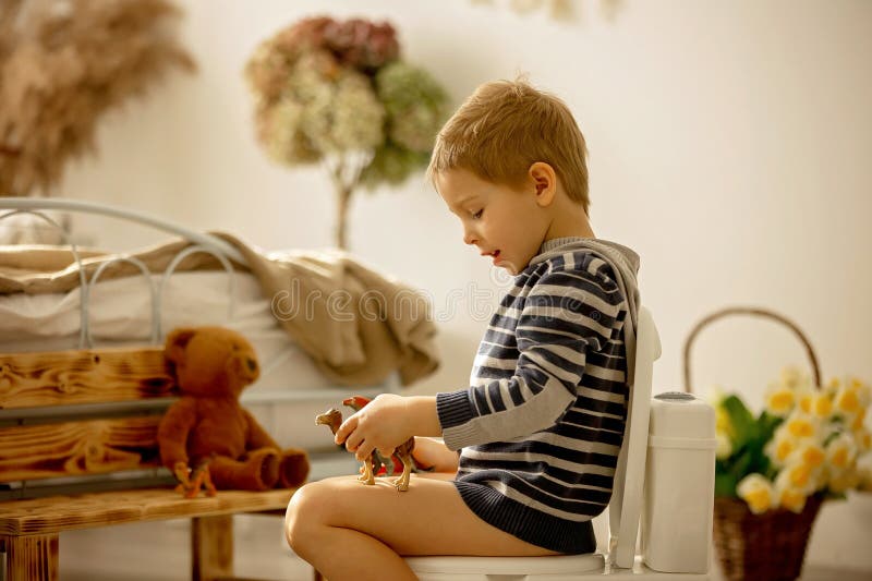 Cute Toddler Child, Boy, Using Potty at Home, while Playing with Toys ...