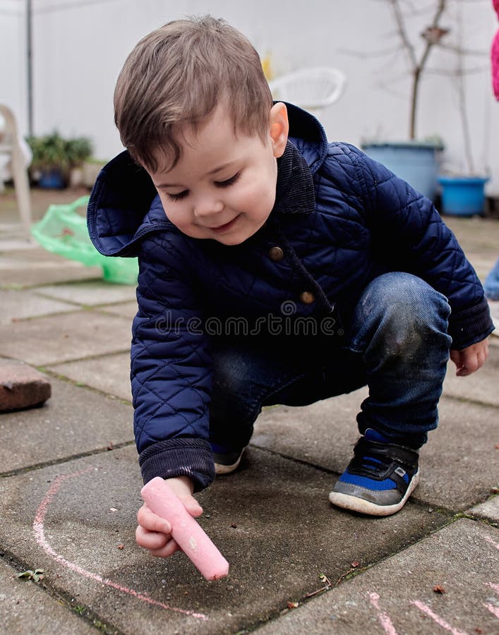 Cute Toddler is Drawing in the Backyard Stock Image - Image of drawing ...