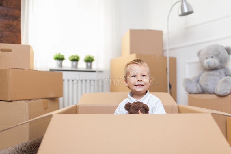 Cute Toddler Helping Out Packing Boxes Stock Photo - Image of children ...