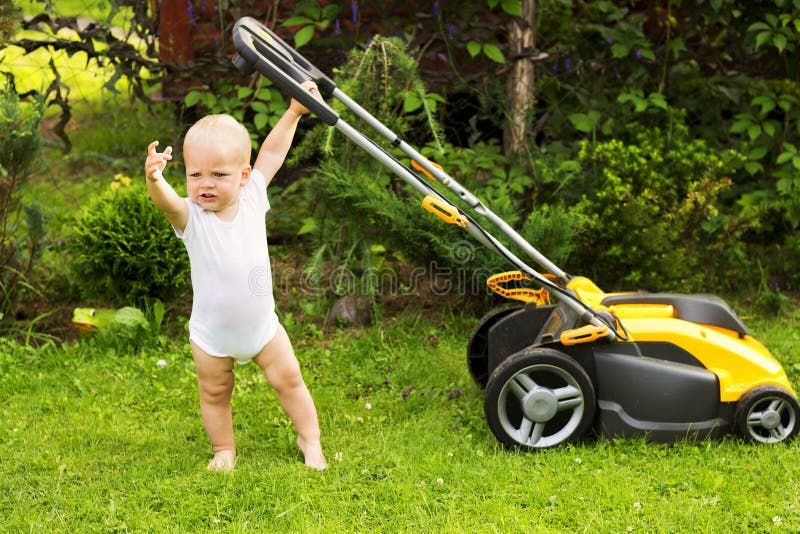 Cute Toddler with a Lawnmower Cutting Grass Stock Photo - Image of lawn ...