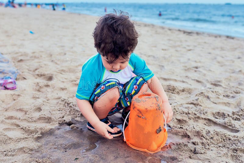 Cute Toddler Playing on the Beach and Trying To Move the Log Stock ...