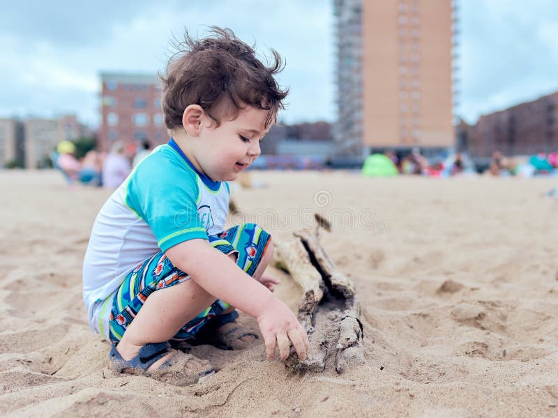 Cute Toddler Playing on the Beach and Trying To Move the Log Stock ...