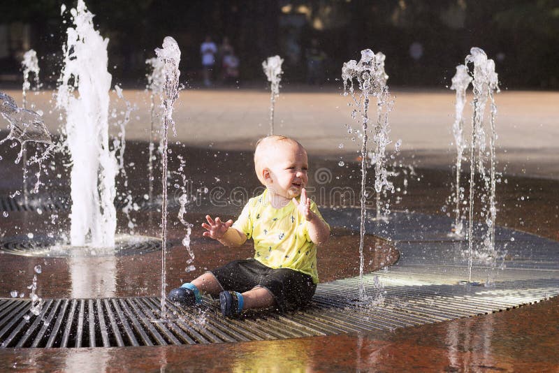 Cute Toddler Playing with Water Streams in Fountain Stock Photo - Image ...