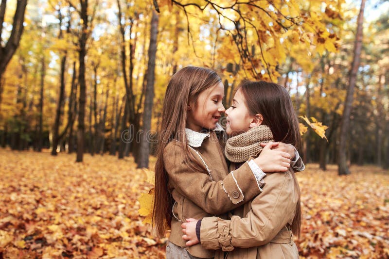 Cute Two Little Sisters Hugging in Autumn Park Outdoor Stock Image ... Cute Two Little Sisters Hugging in Autumn Park Outdoor Stock Image ...