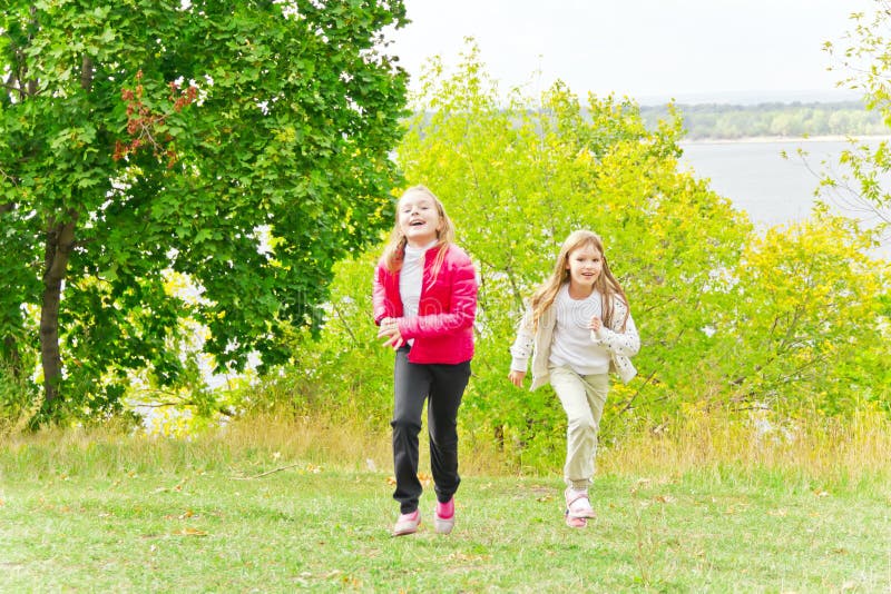 Cute two running girls stock photo. Image of european - 74107372