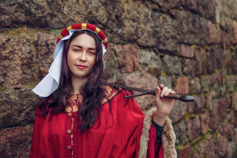 Cute Woman Holding a Sword on Her Shoulder Leaning Her Shoulder on the ...