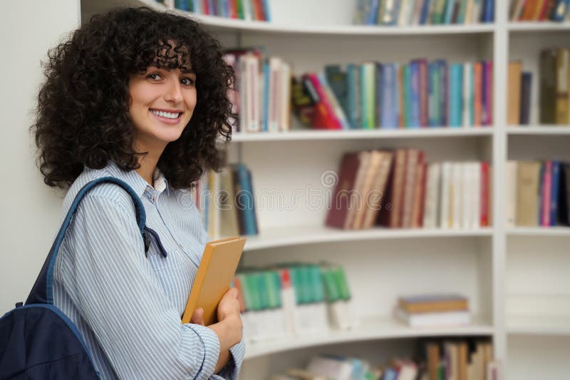 Cute Woman in the Library Smiling Nicely and Looking Contented Stock ...