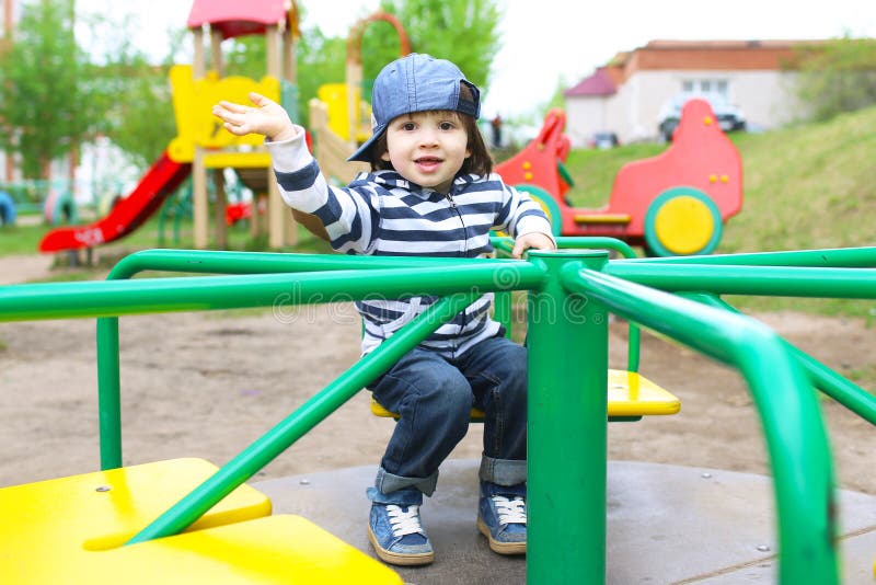 Cute 2 Years Boy on Merry-go-round Outdoors Stock Photo - Image of ...