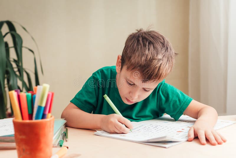 Cute 7 Years Old Child Doing His Homework Sitting by Desk Stock Image ...