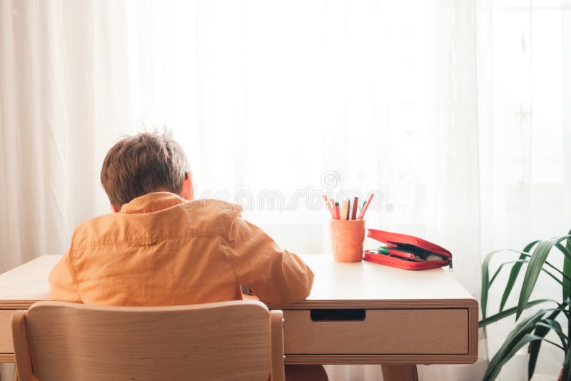 Cute 7 Years Old Child Doing His Homework Sitting by Desk Stock Image ...