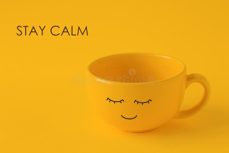 Yellow Cup with Eyes and Mouth and Note Stay Calm on a Yellow ...