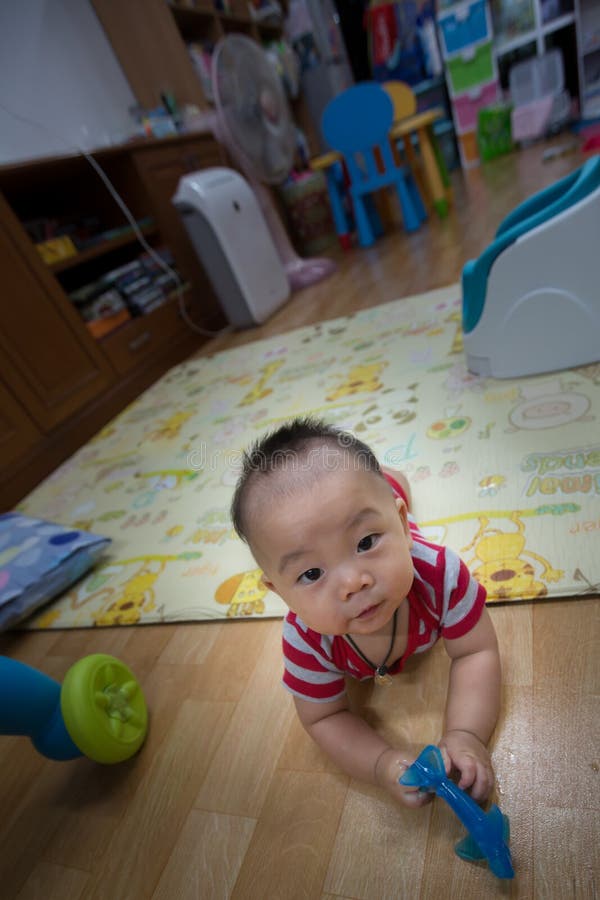 A Cute Young Baby Playing Inside Home Stock Photo - Image of little ...
