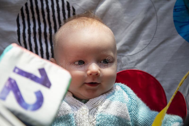 A Cute Young Baby Playing on a Sensory Development Activity Playmat ...