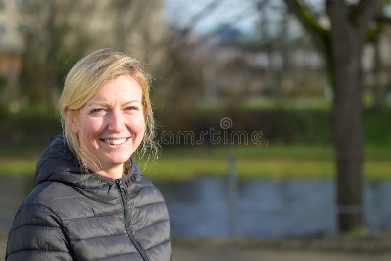 Cute Young Blond Woman with an Impish Grin Stock Image - Image of young ...