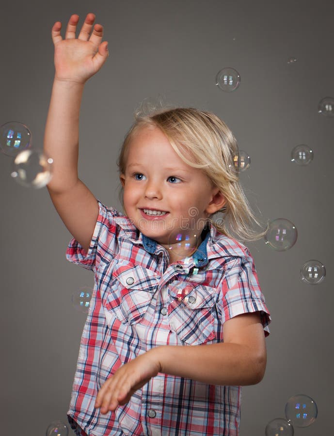Cute Young Boy Catching Bubbles Stock Image - Image of play, child ...