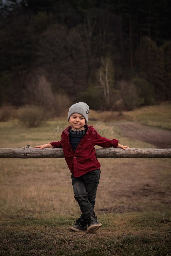 Cute Young Boy Holding a Log in the Spring Garden Stock Image - Image ...