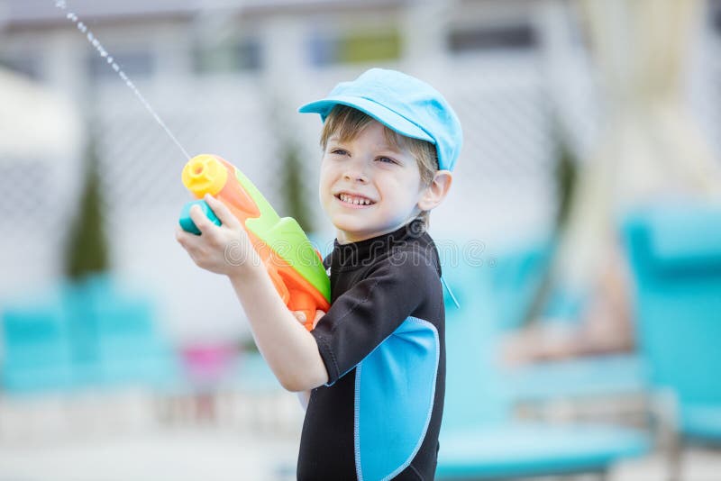 Young Boy Shooting Water Gun Outdoors Stock Image - Image of outdoor ...