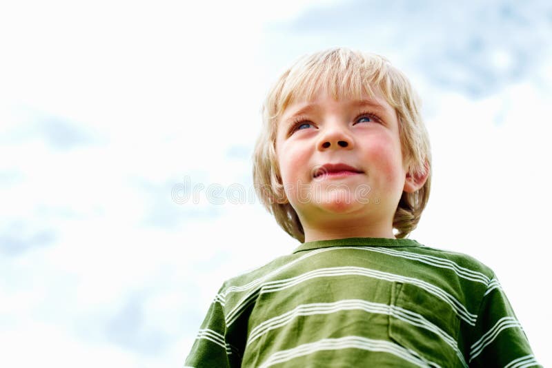 Cute Young Boy Smiling. Low Angle View of Cute Young Boy Standing ...