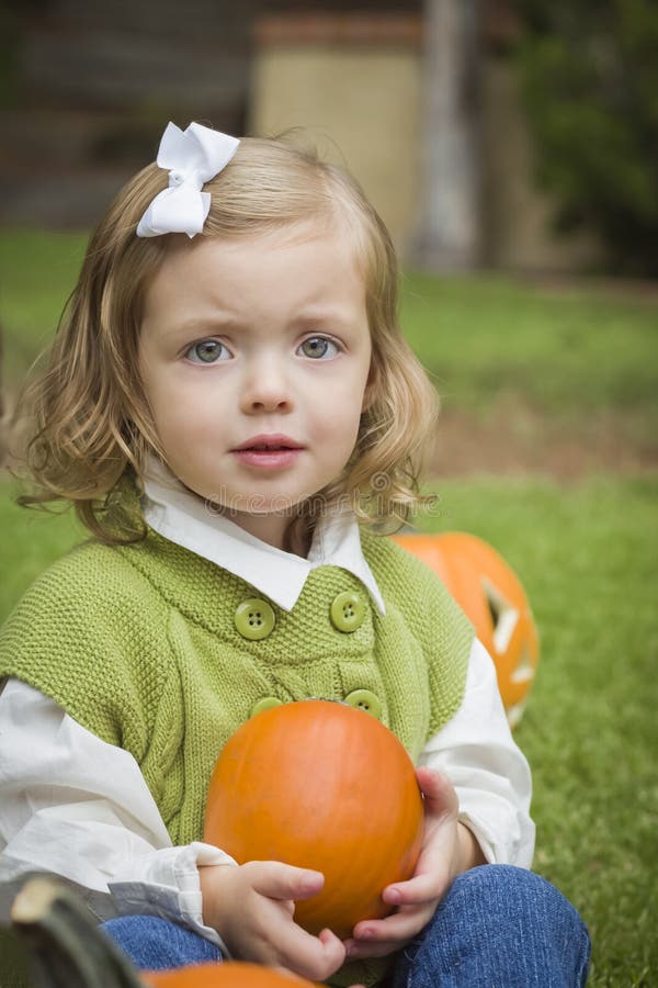 Cute Young Child Girl Enjoying the Pumpkin Patch. Stock Image - Image ...