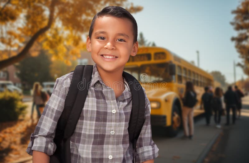 Cute Young Hispanic Boy Wearing a Backpack Near a School Bus on Campus ...