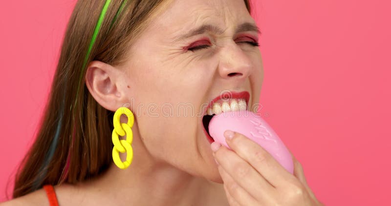 A Cute Teenage Girl with Long Hair is Sitting on the Table in the ...