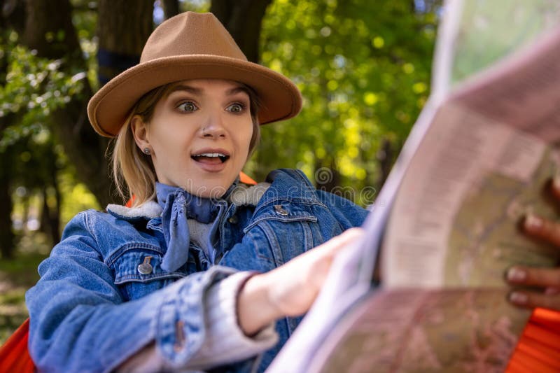 Cute Young Woman with a Map in Hands Looking for New Destination Stock ...