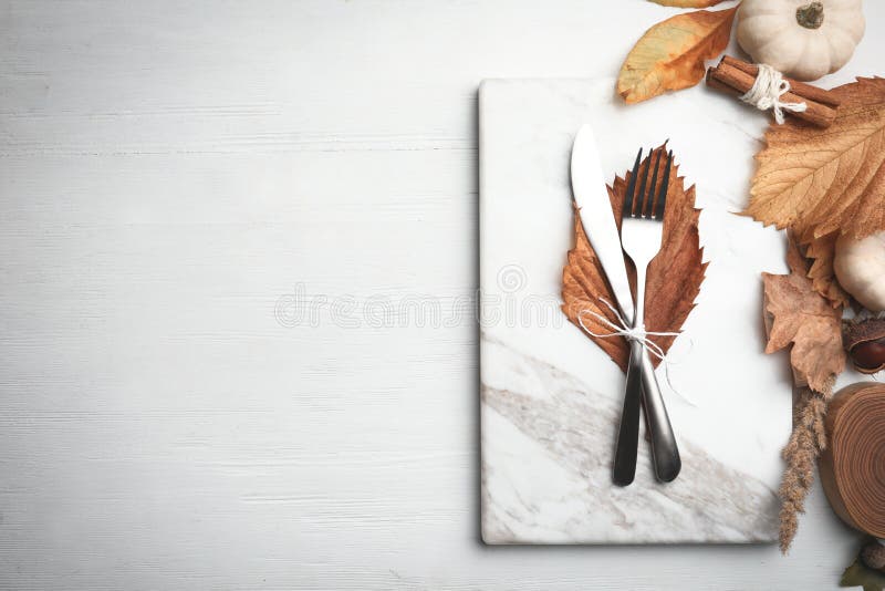 Cutlery, Dry Leaves and Marble Board on White Wooden Background, Flat ...