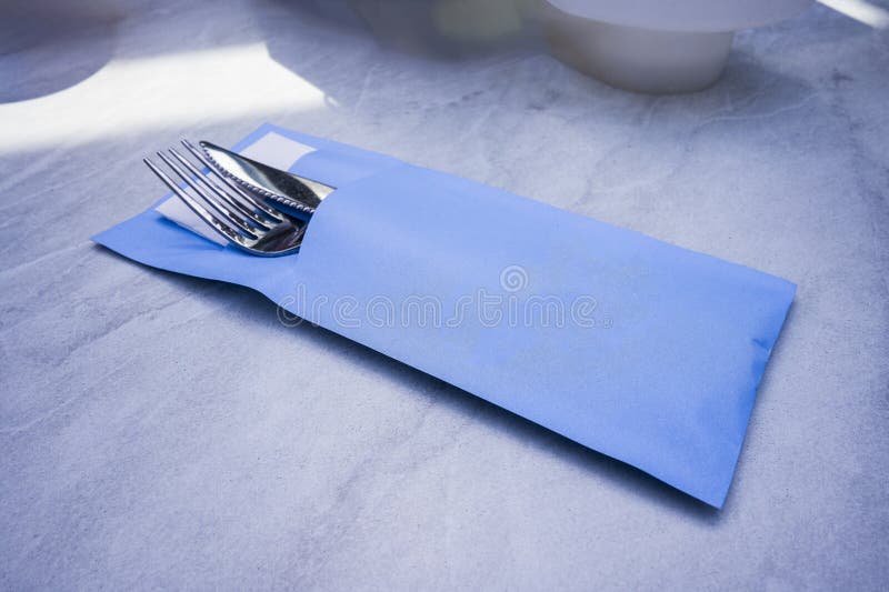 Cutlery Set with Fork, Knife, and Tissue Wrapped Inside a Blue Paper ...